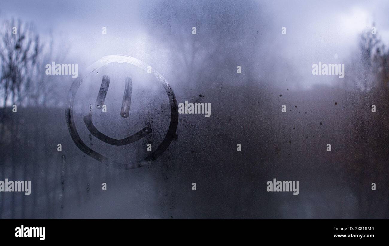 happy smiley face painted on a foggy window, a cold background Stock ...