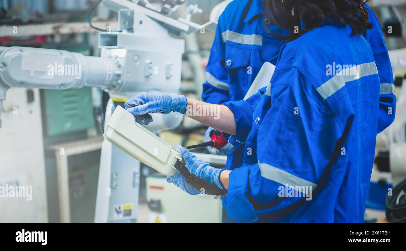 Engineers team mechanic using computer controller Robotic arm for ...