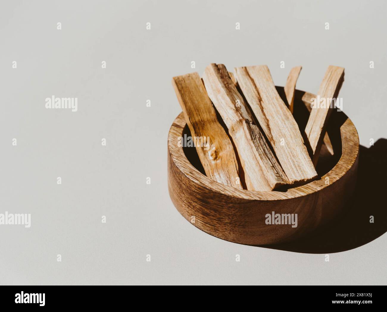 Palo Santo sticks in wood box on a light background. A set of incense ...