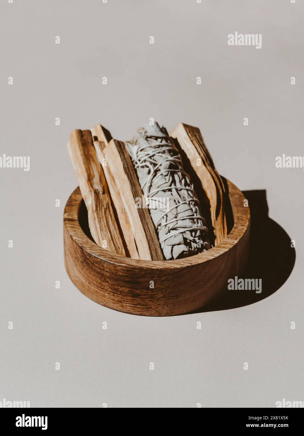 White sage and Palo Santo sticks in wood box on a light background. A ...