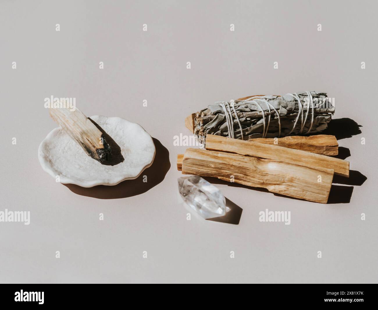 White sage and Palo Santo on a light beige background. A set of incense ...
