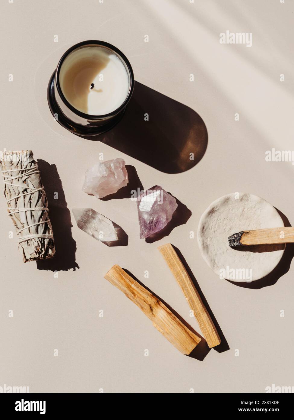 White sage and Palo Santo and amethyst and quartz crystals on a light ...
