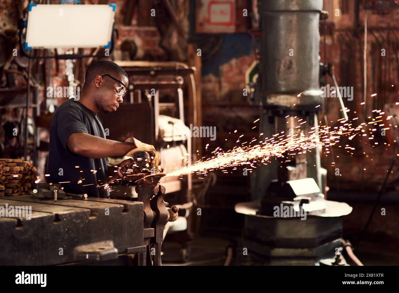 Blacksmith, factory or black man in workshop and sparks, manual labor ...