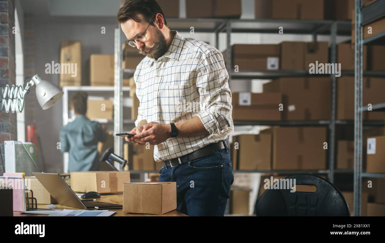 Storeroom Inventory Worker Using Smartphone to Scan a Barcode on Parcel ...