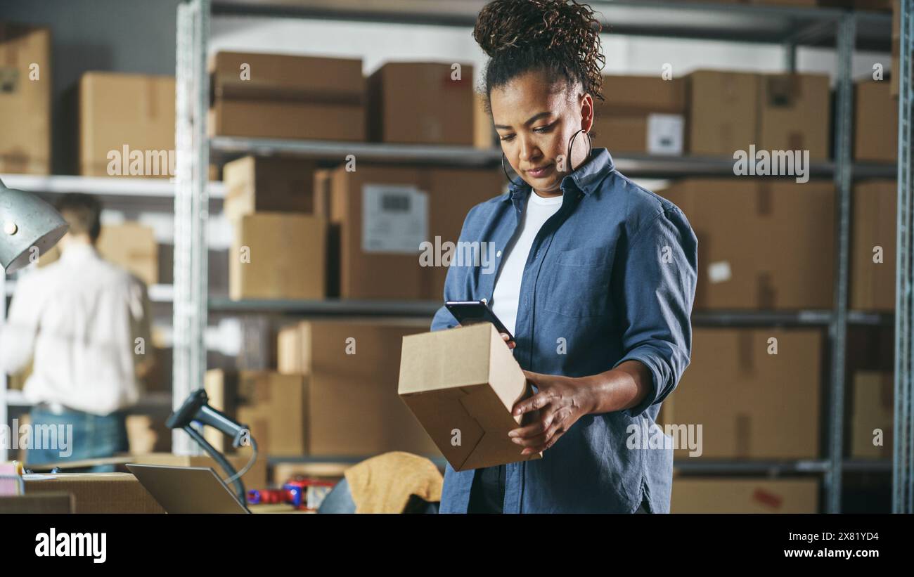 Storeroom Inventory Worker Using Smartphone to Scan a Barcode on Parcel ...