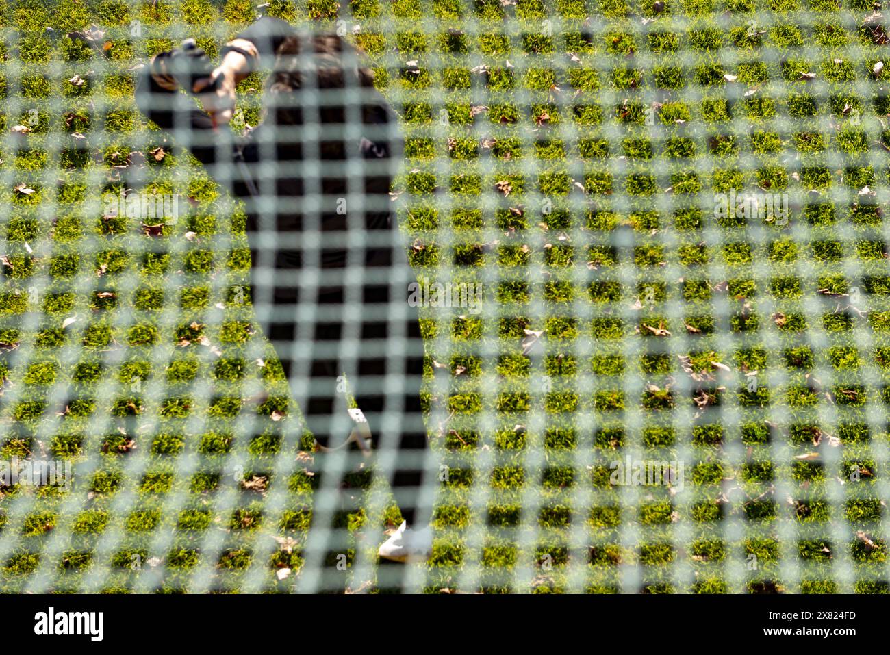 Golfer Training on Driving Range Behind a Net Stock Photo - Alamy