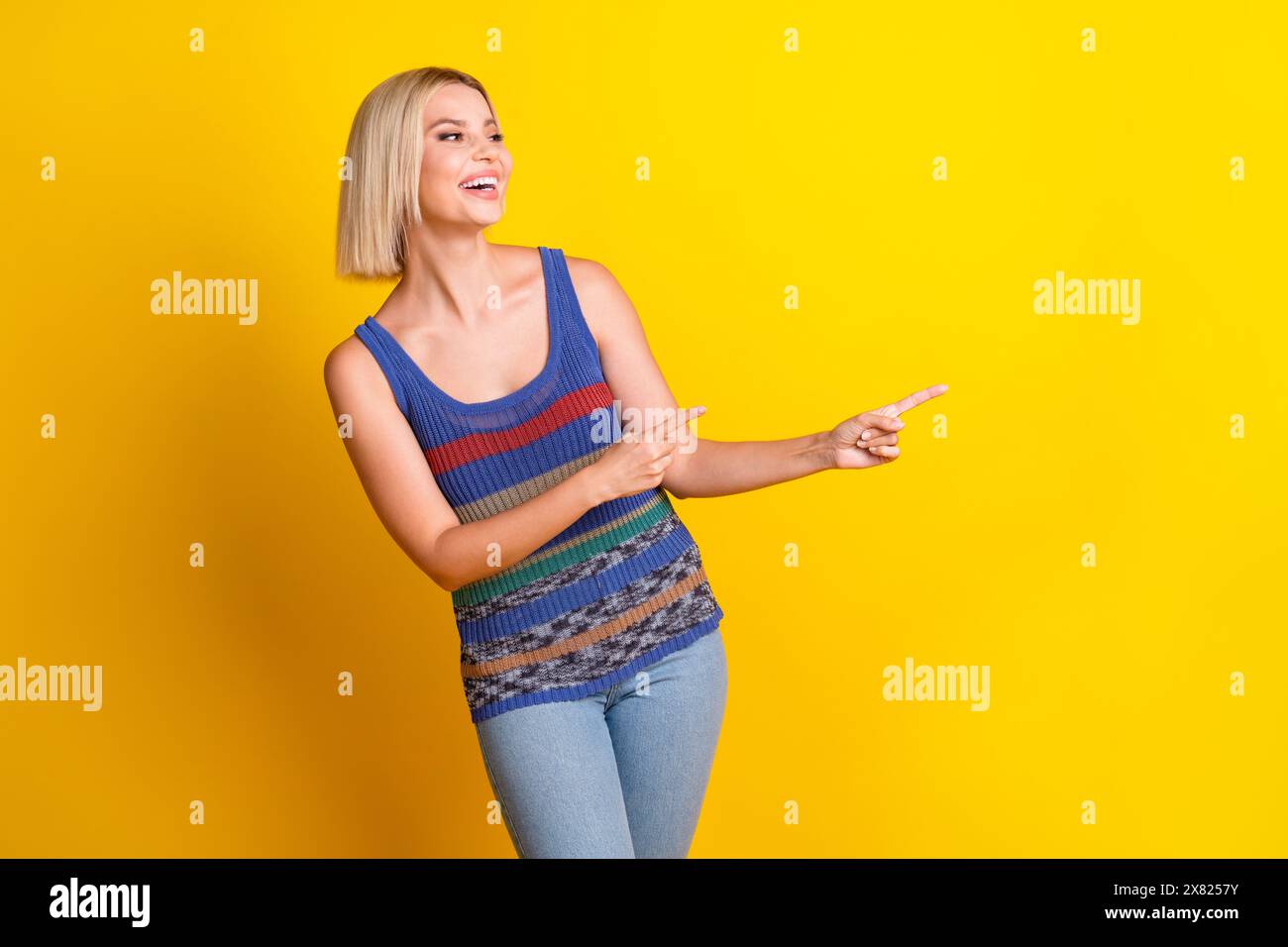 Photo of young sweet beautiful woman in singlet pointing fingers promo ...