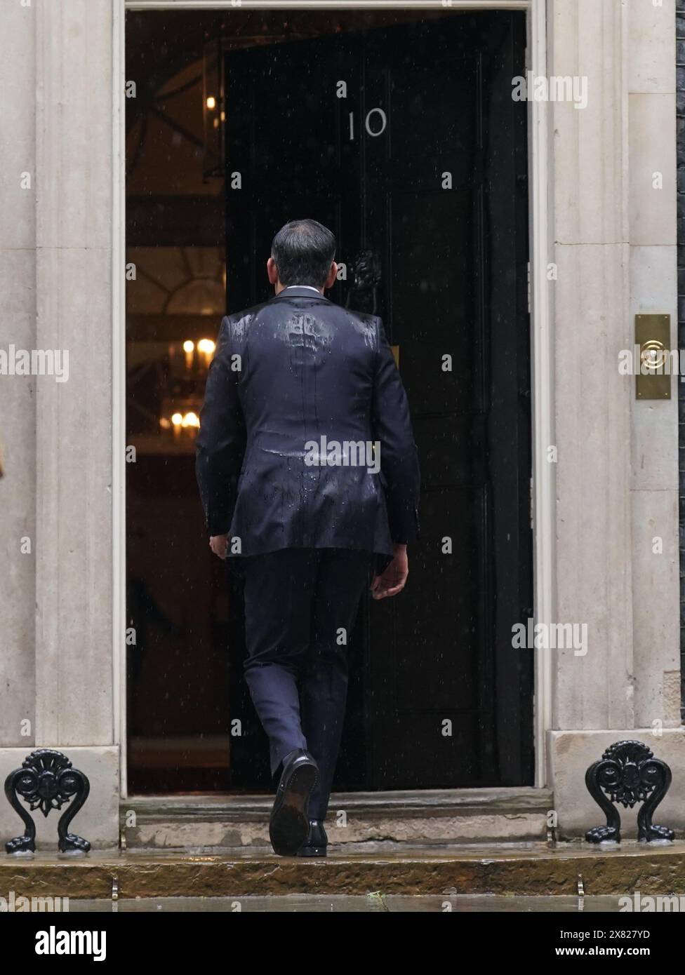 Prime Minister Rishi Sunak, soaked by rain, walks back in to 10 Downing ...