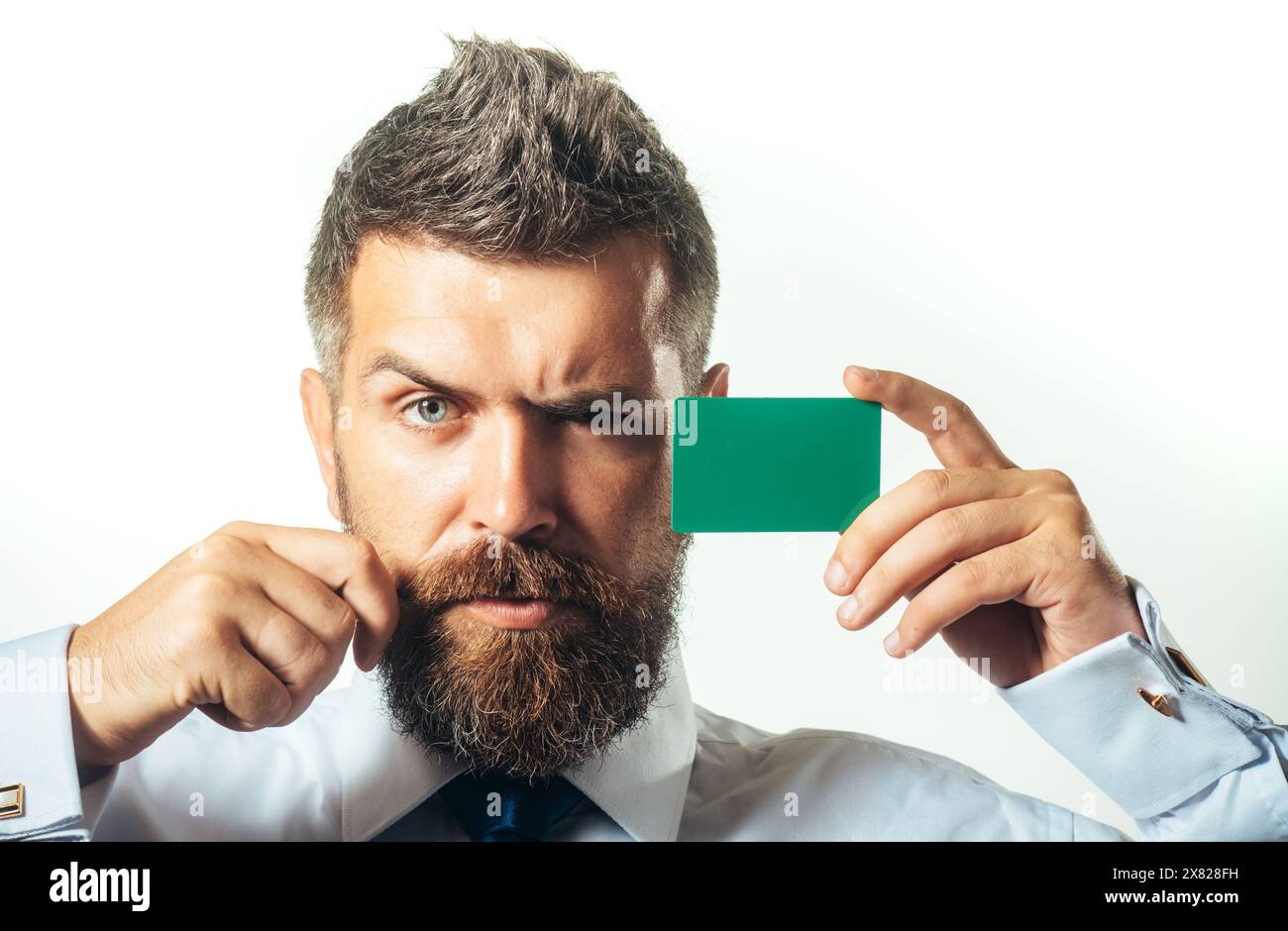 Serious bearded man in formal wear showing blank mockup empty business ...