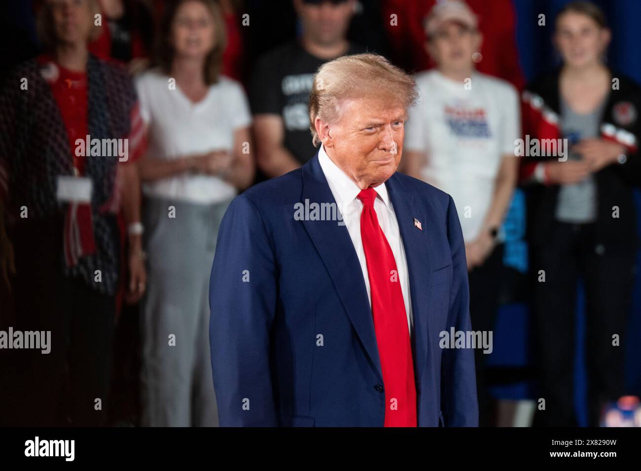 Donald Trump walks on stage and flashes a flirty facial expression at a ...