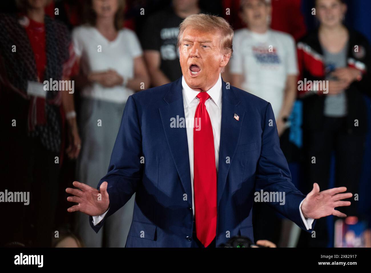Donald Trump walks on stage with his mouth wide open at a campaign ...