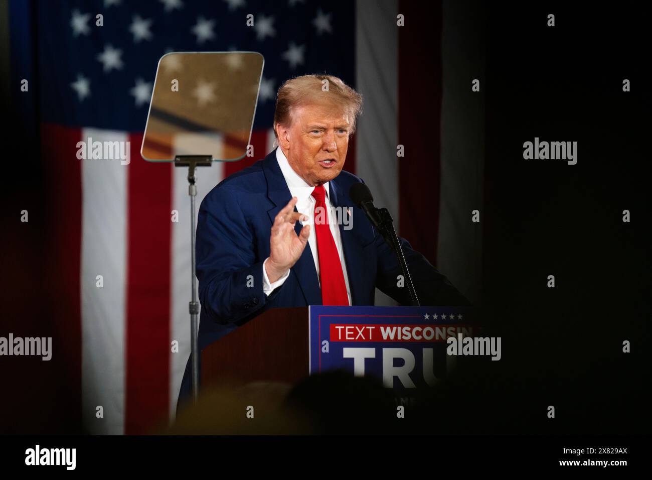 Donald Trump uses a hand gesture to illustrate something small while ...