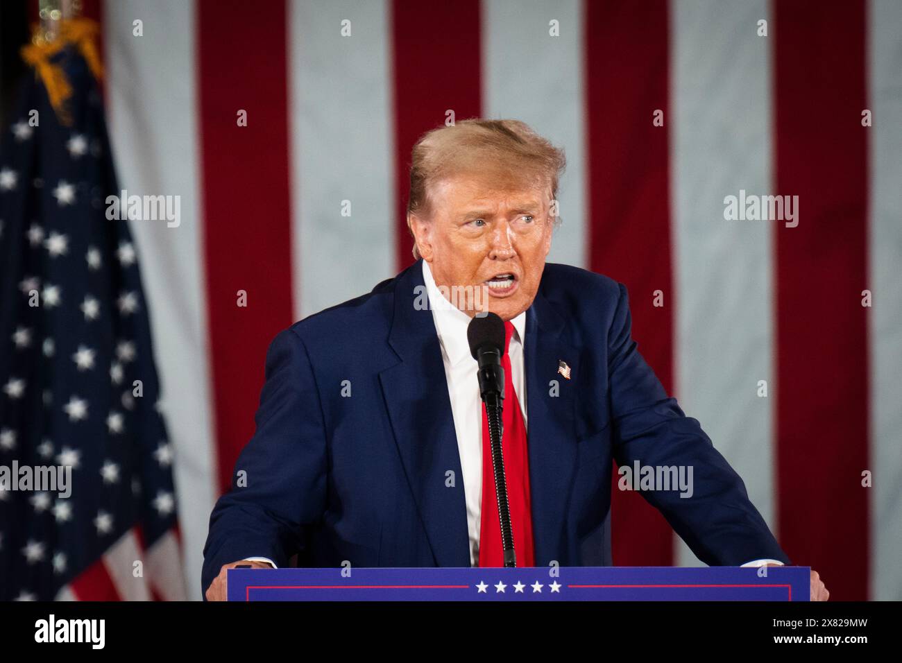 Donald Trump speaks on stage at a campaign rally in Waukesha, Wisconsin ...