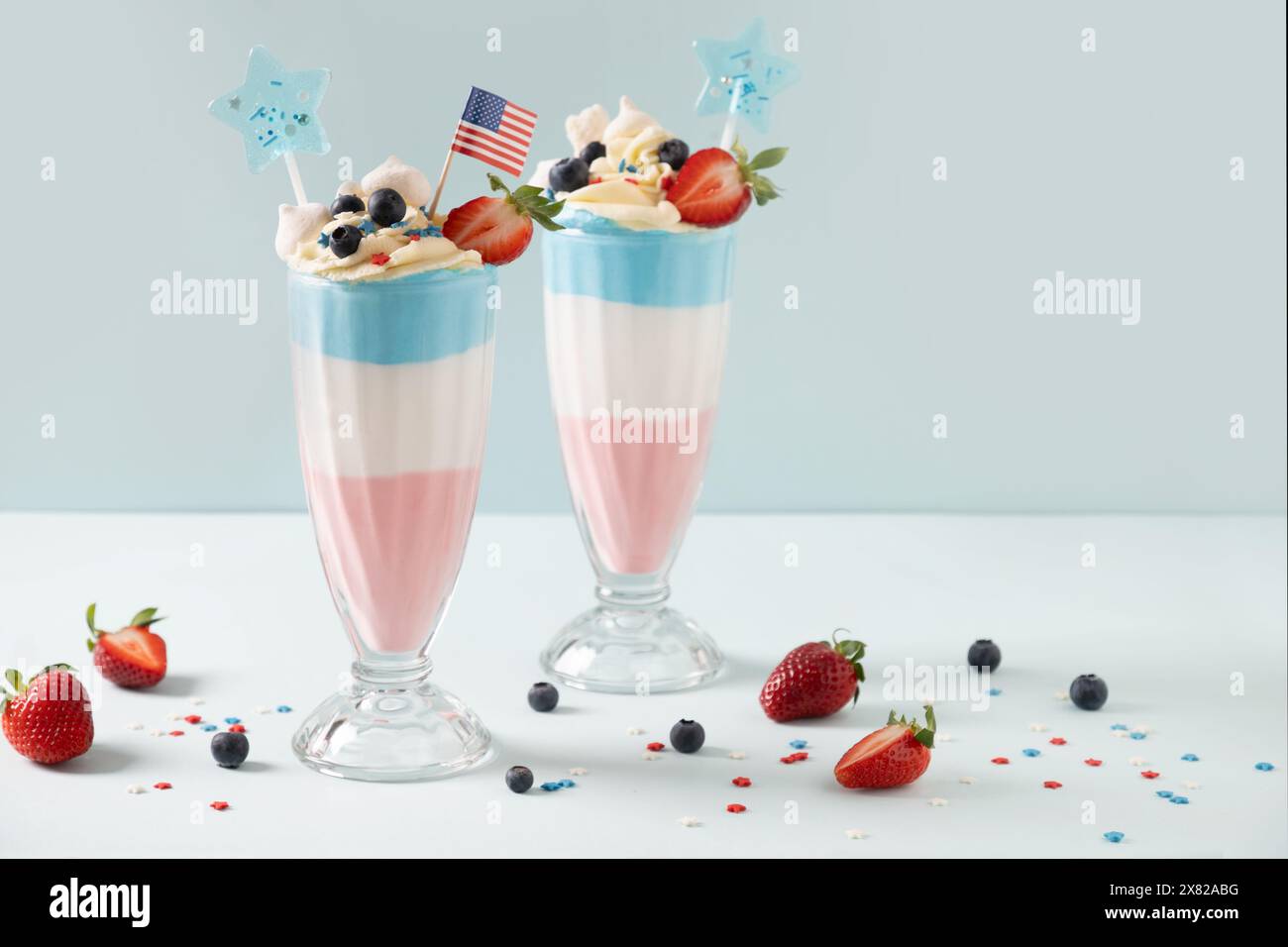 Layered milkshake or sweet dessert in red, white and blue colors on ...