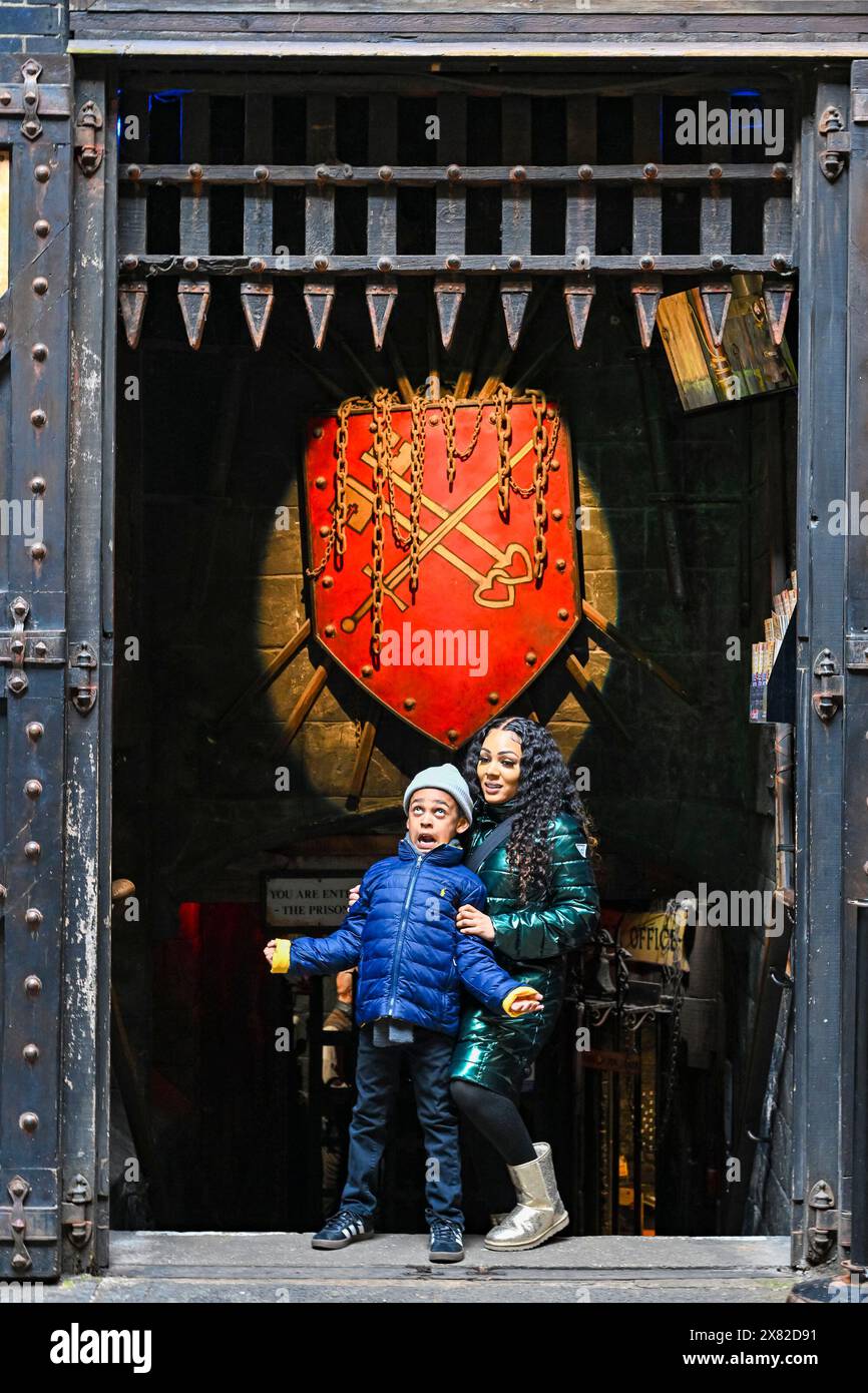 A young child and an adult female pose in front of the open doorway to ...