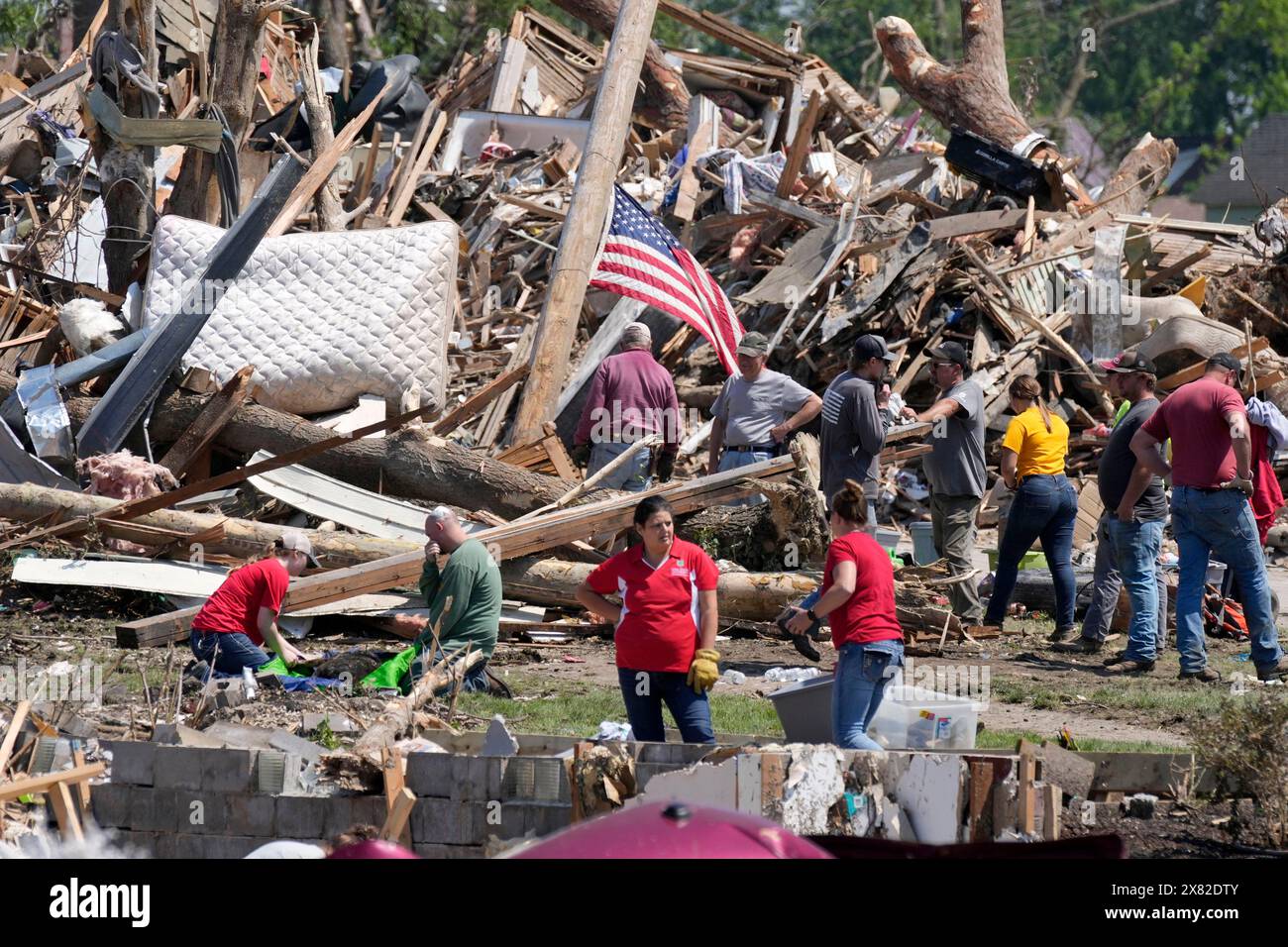 Local residents clean up debris from a tornado damaged home, Wednesday ...