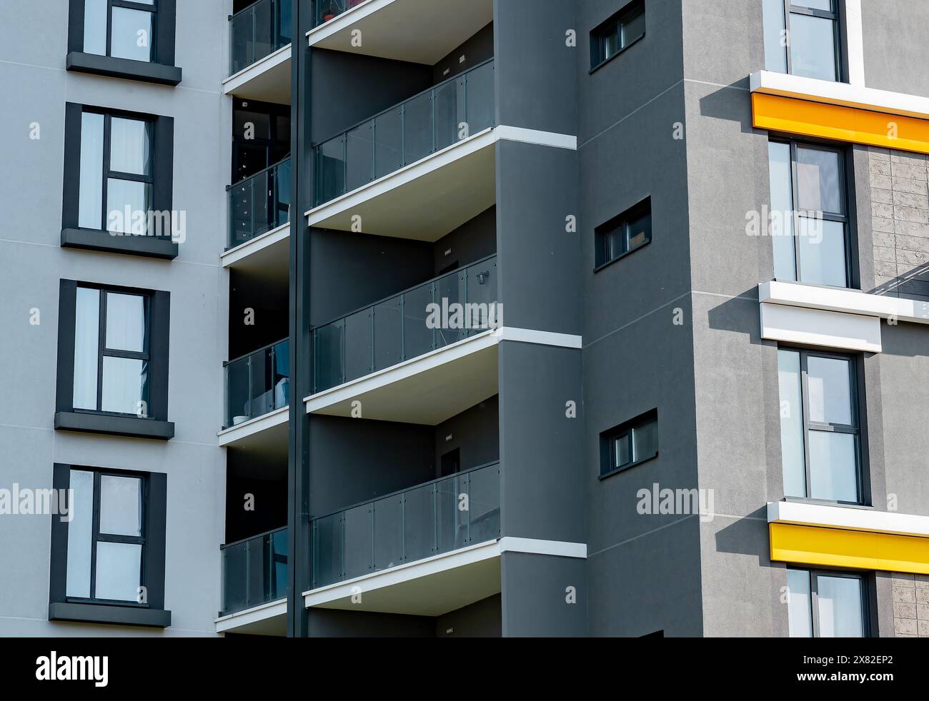 Modern residential building with detailed brick facade and high glass ...
