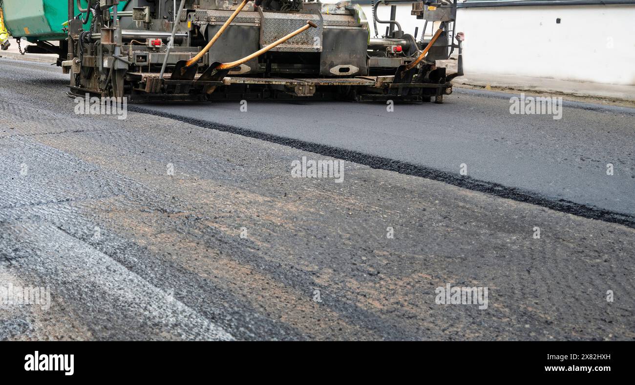 Repair of asphalt road surface - old layer removed and a coating ...