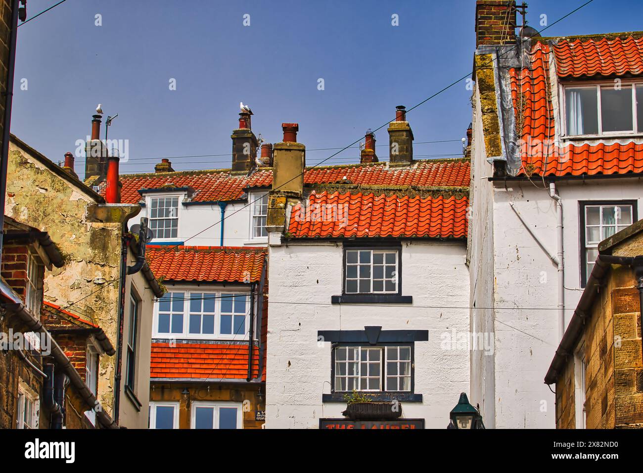 A picturesque view of traditional European houses with red-tiled roofs ...