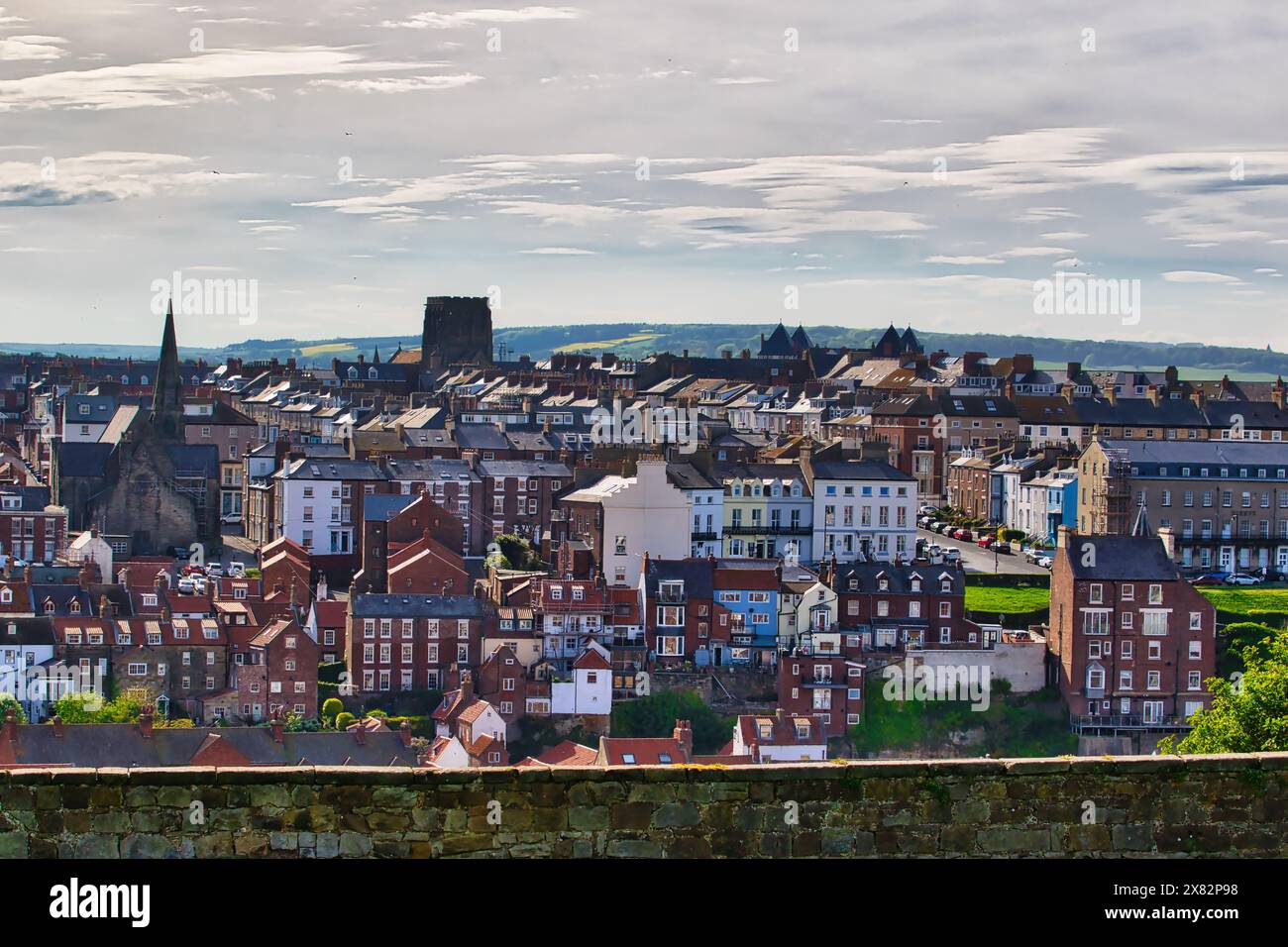 A panoramic view of a coastal town with a mix of historic and modern ...
