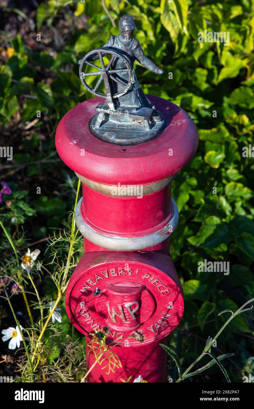 Suffolk, UK - October 28th 2023: A sculpture of a Weaver on a red ...