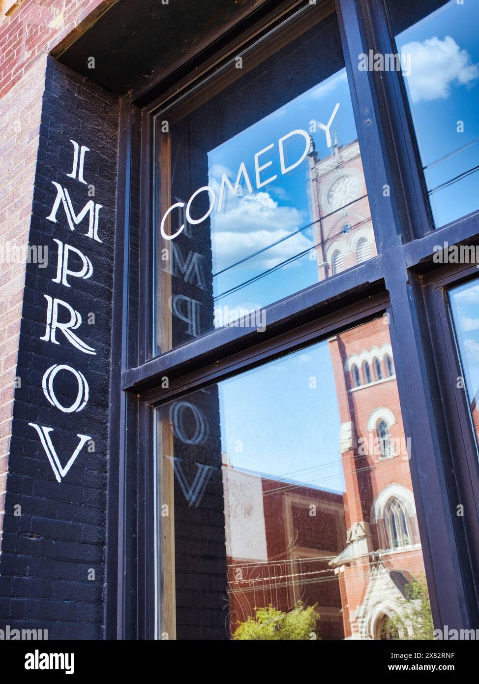 improv / comedy club sign with reflection in window Stock Photo - Alamy