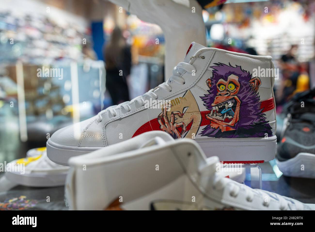 The art of painting shoes. A colorful Puma sneakers painted freshly ...