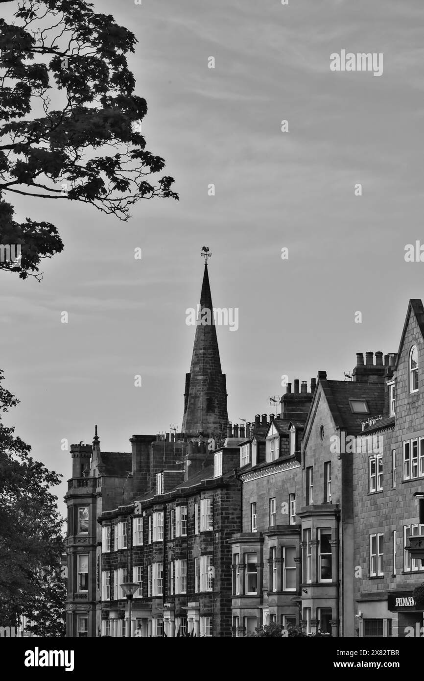 Black and white photo of a row of old buildings with a church steeple ...