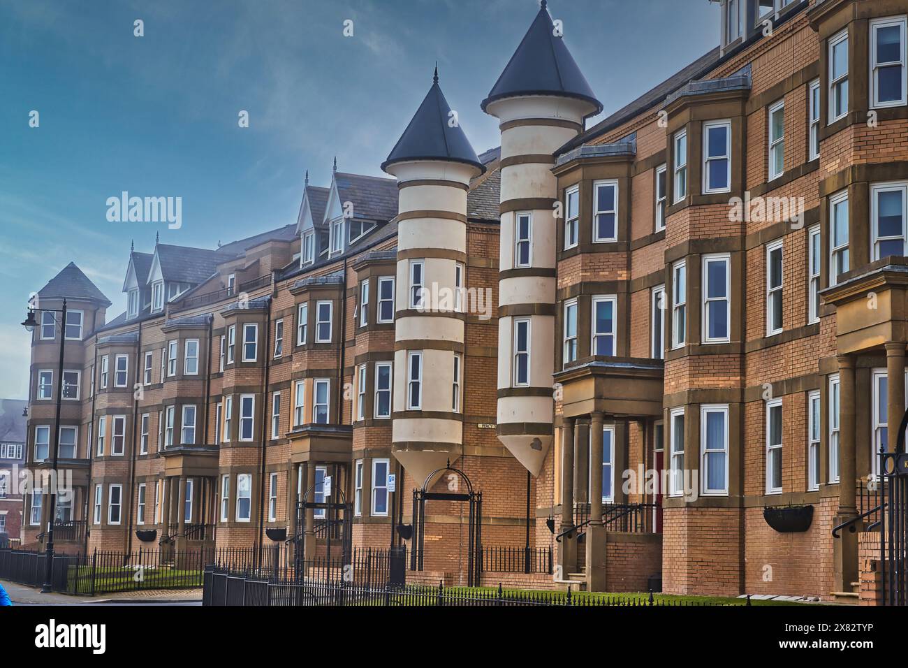 A row of modern brick apartment buildings with unique cylindrical ...