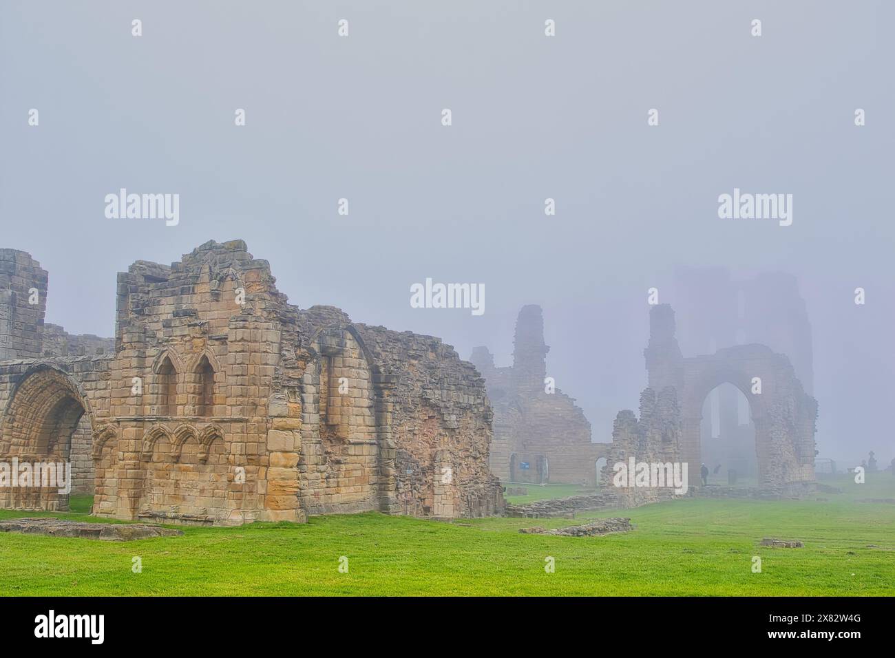 Ancient stone ruins of a building with arches and walls, surrounded by ...