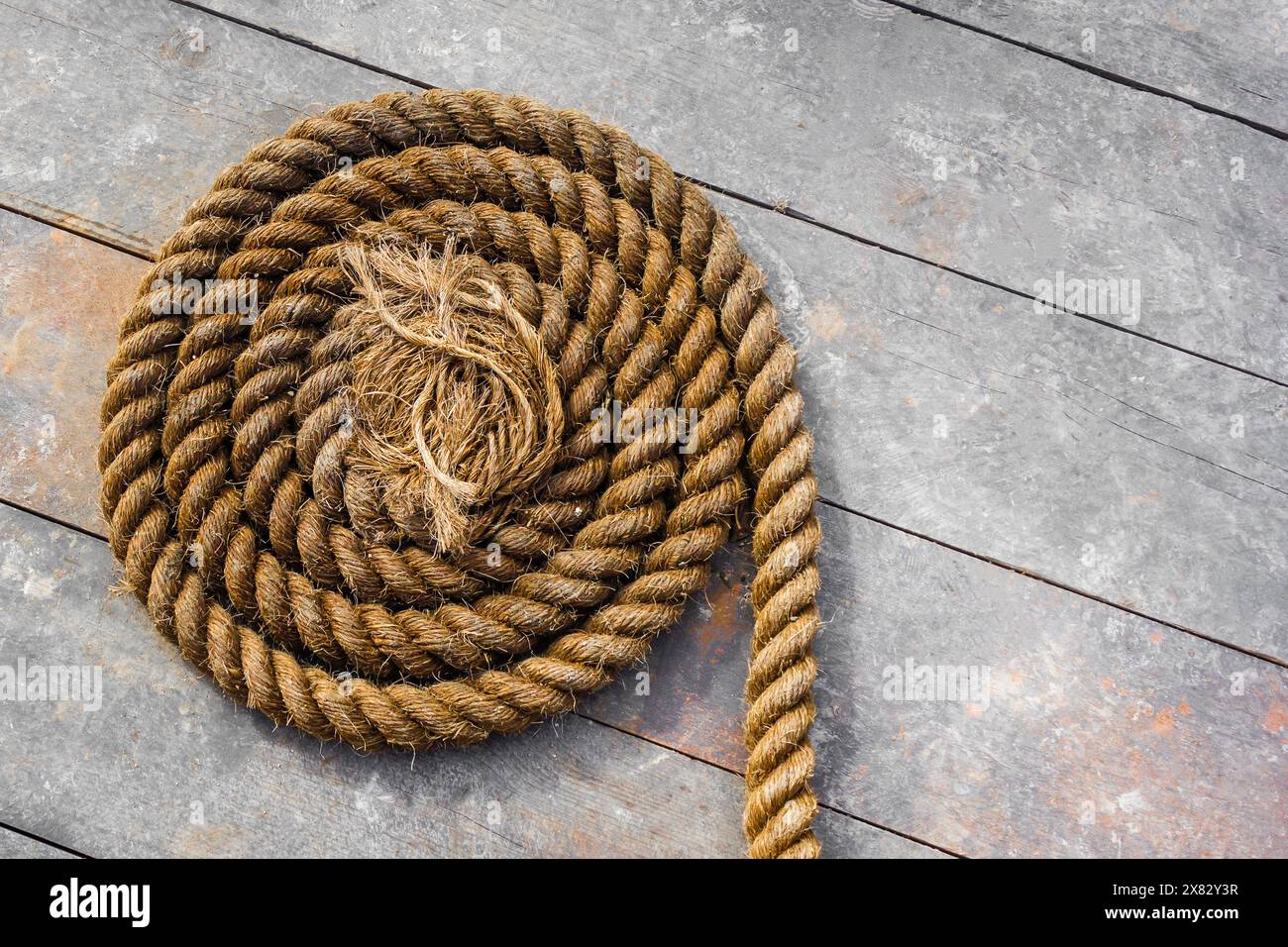 a brown round rope on the boat deck taken from the top view Stock Photo ...