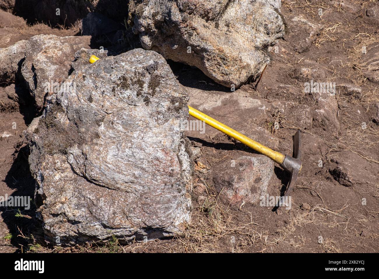 pickaxe with a yellow plastic handle in an archaeological excavation ...