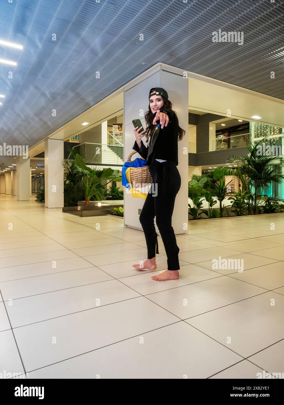 Beautiful black-haired girl on the street, fashion shoot. Wide angle ...
