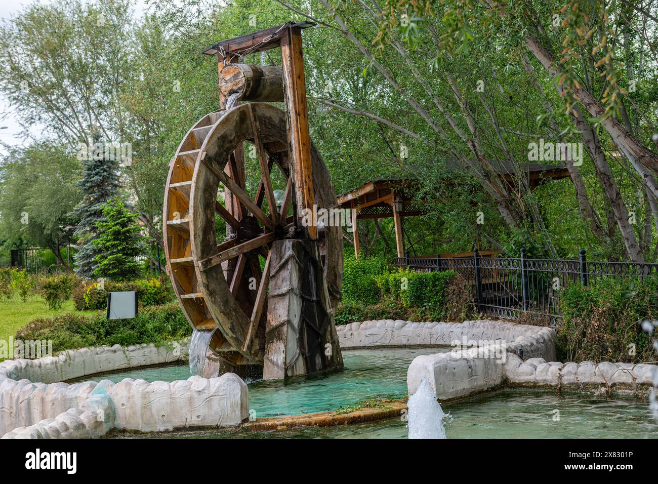 Water mill wheel and waterfall on the river. Sustainable energy and ...