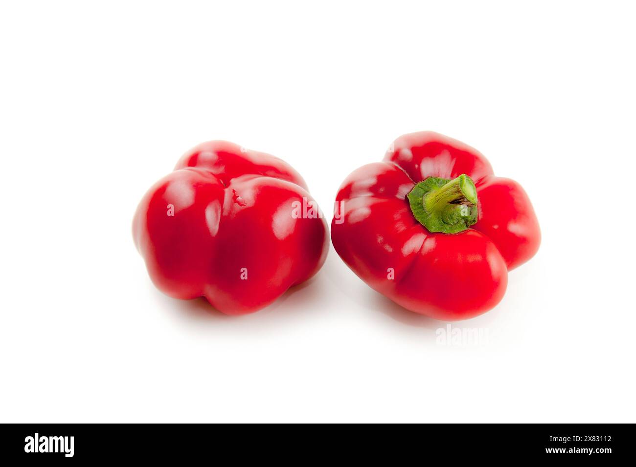 Two round red bell pepper (capsicum) known as sweet bell pepper ...