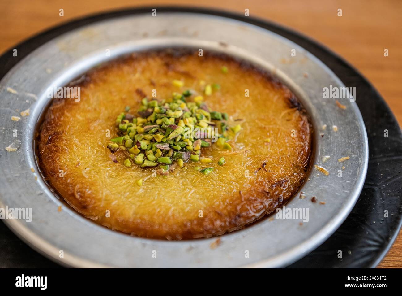 Delicious traditional Turkish kunefe with pistachio on it. Served hot ...