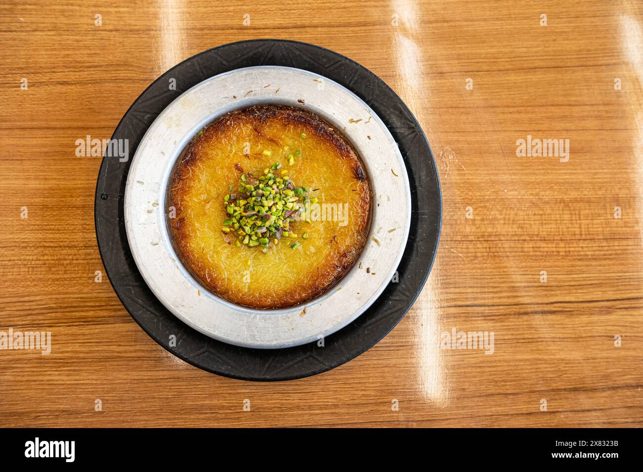 Delicious traditional Turkish kunefe with pistachio on it. Served hot ...