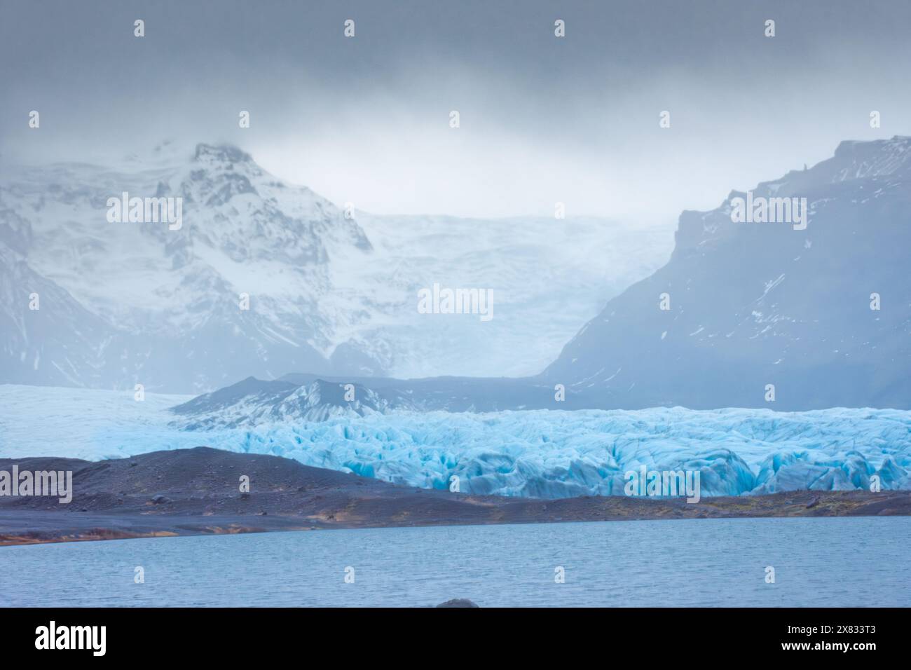 Icebergs from the melting Fjallsjokull Glacier under the rain, Iceland ...