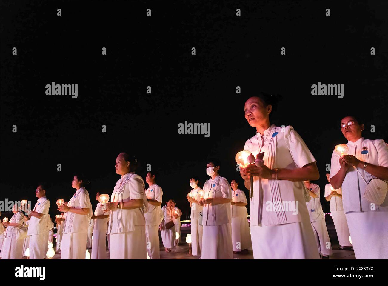 Pathum Thani, Thailand. 22nd May, 2024. Buddhist devotees pray during ...