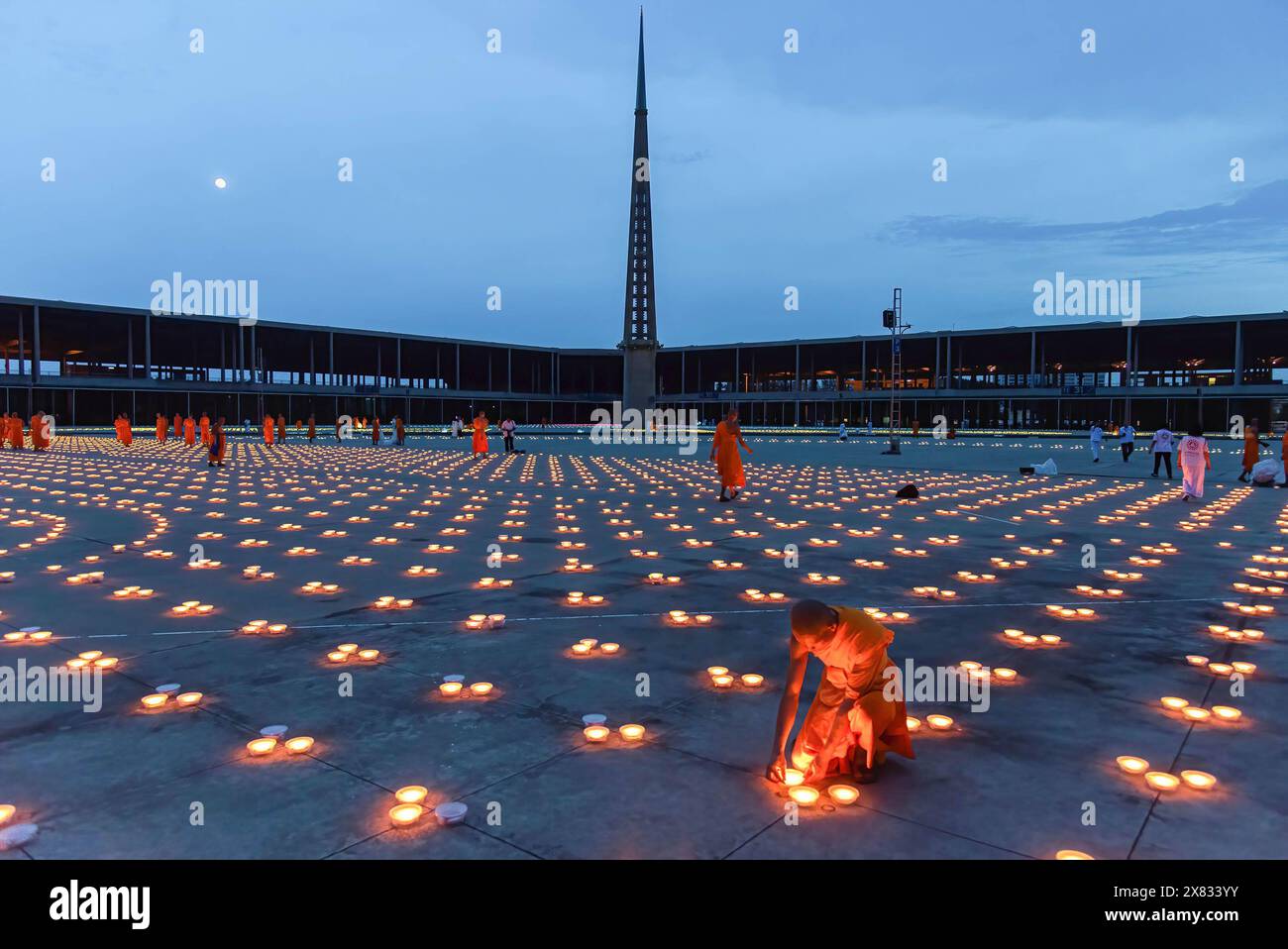 Pathum Thani, Thailand. 22nd May, 2024. A Buddhist monk sets LED lamps ...