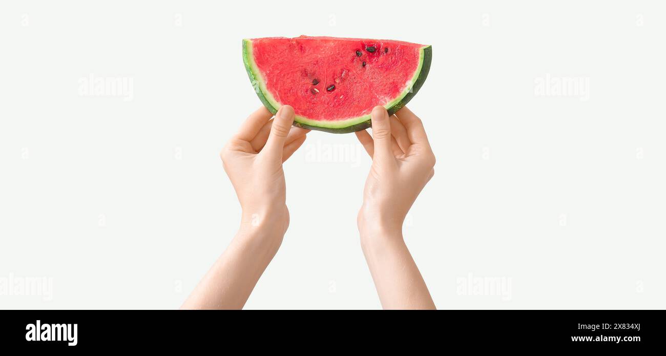 Hands with piece of ripe watermelon on light background Stock Photo - Alamy