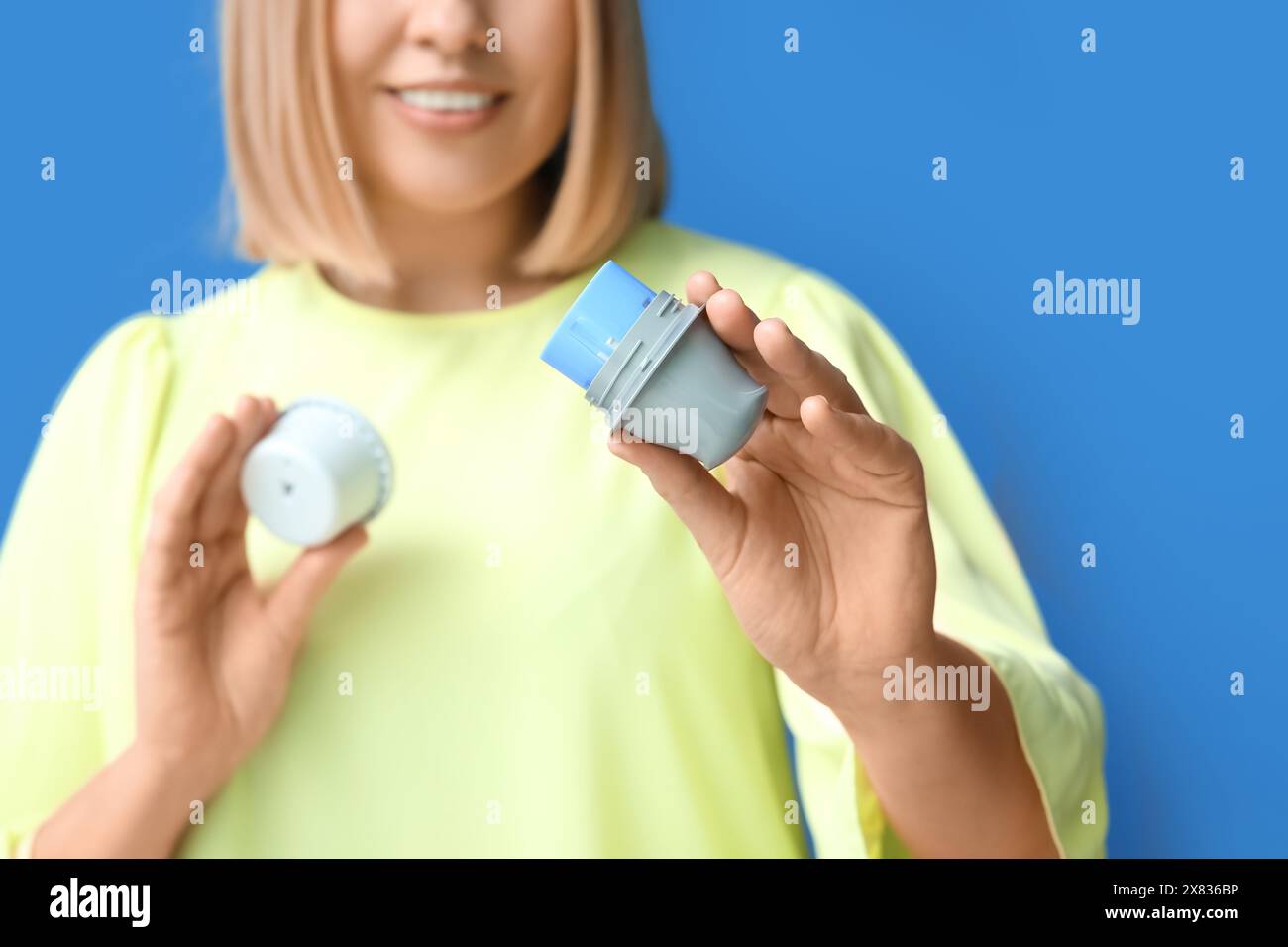 Woman with glucose sensor for measuring blood sugar level and ...