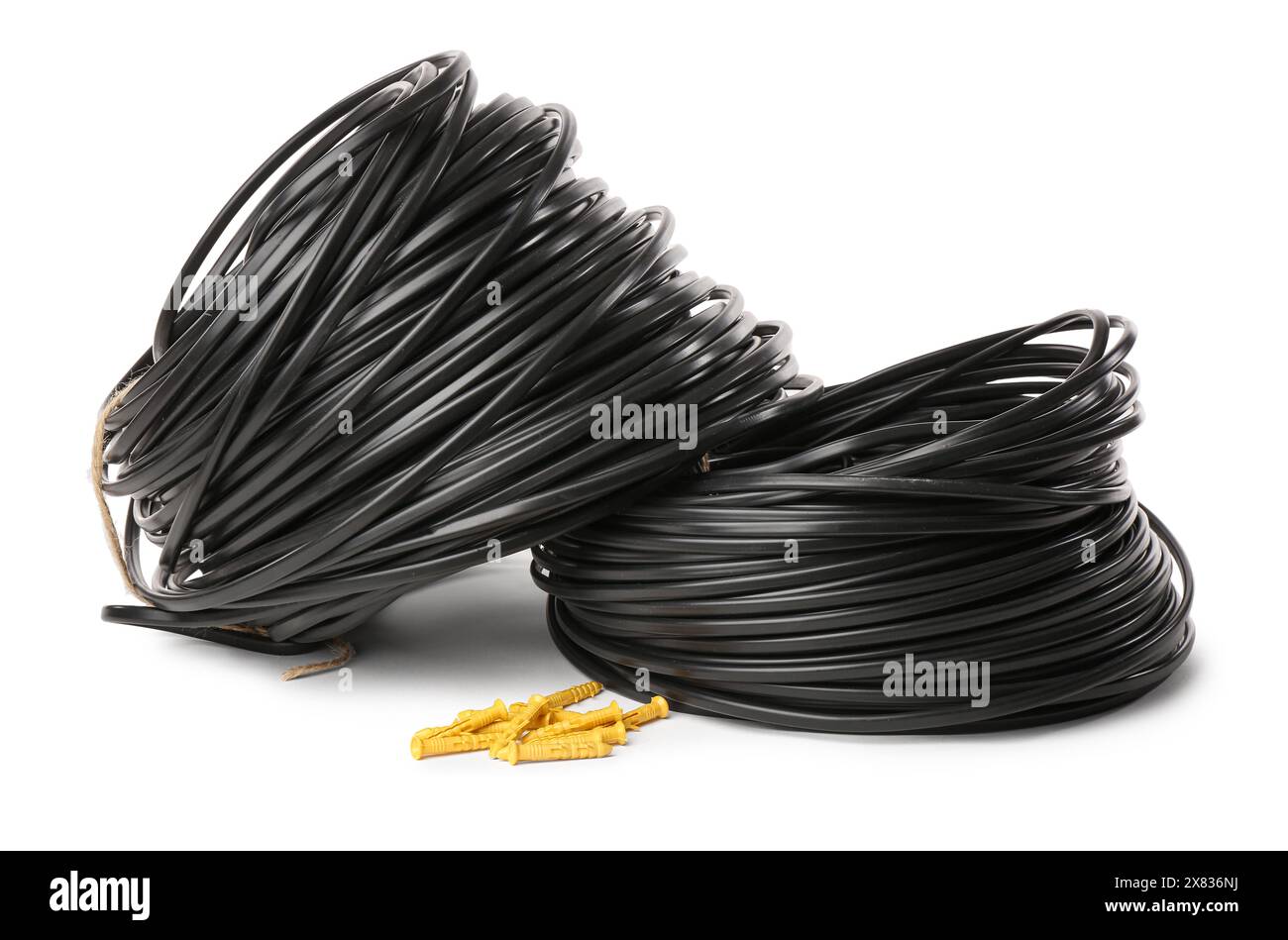 Rolled cables and wall plugs on white background Stock Photo - Alamy