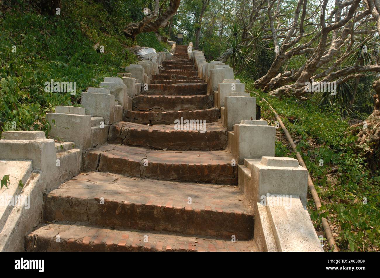 Tourist climbing steps up to Wat Chom Si on Phou Si Hill, Luang Prabang ...