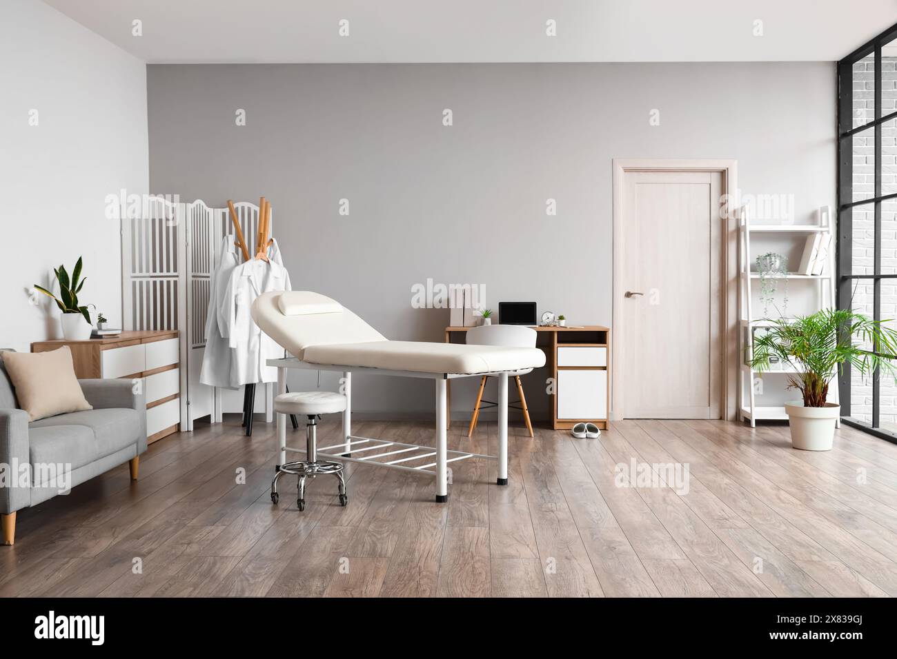 Interior of medical office with couch, sofa and doctor's workplace ...