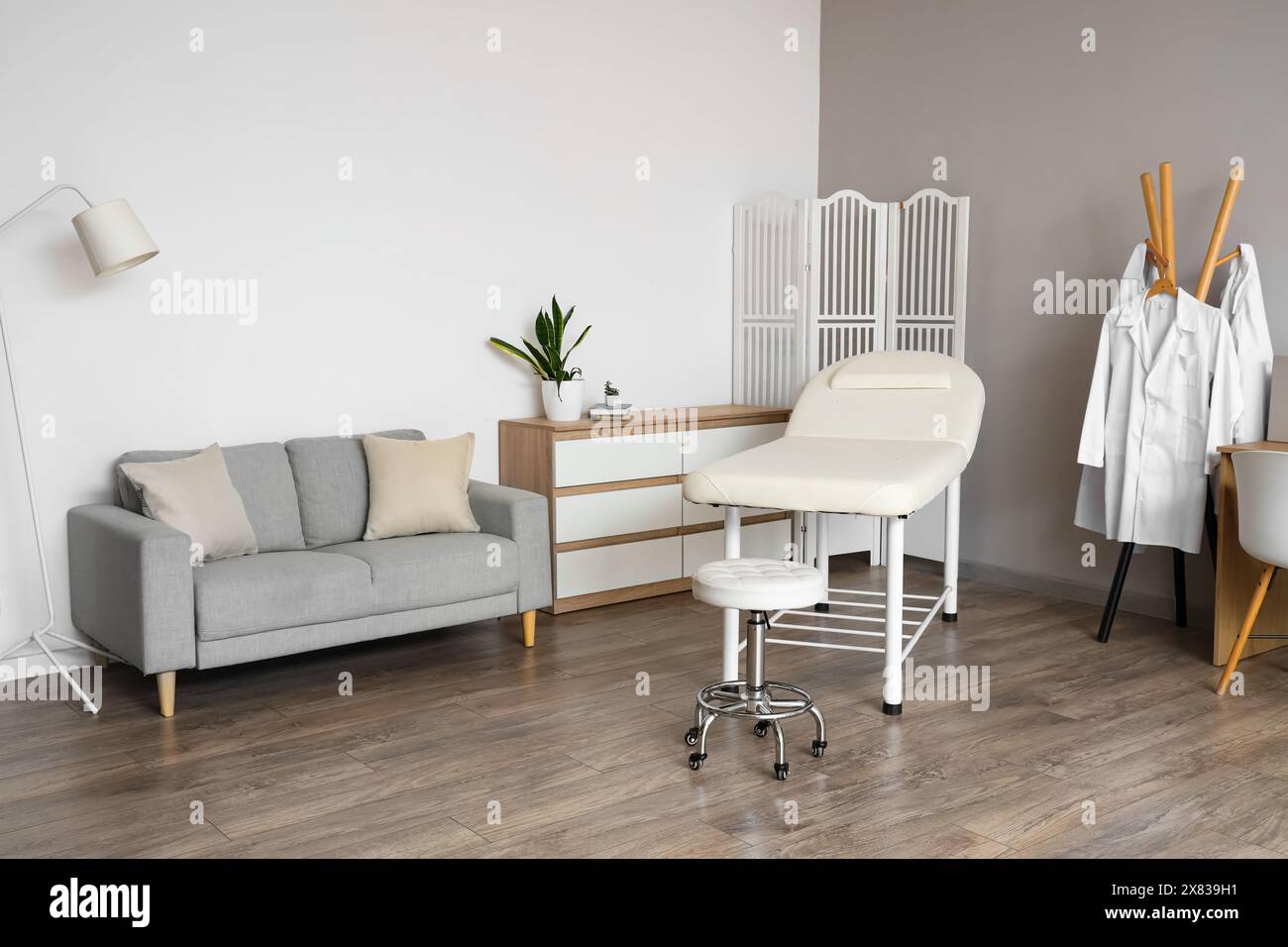 Interior of medical office with couch, sofa and clothes rack Stock ...