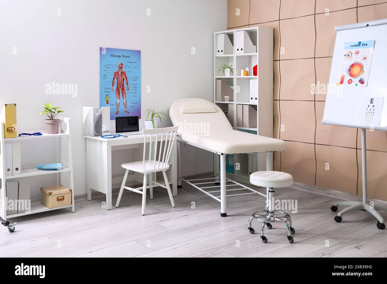 Interior of medical office with couch, shelf units and doctor's ...