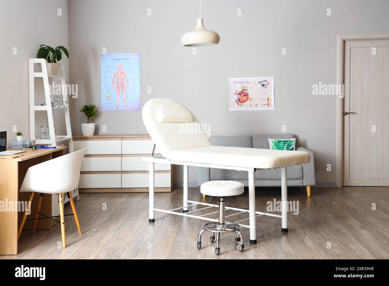 Interior of medical office with couch, drawers and doctor's workplace ...