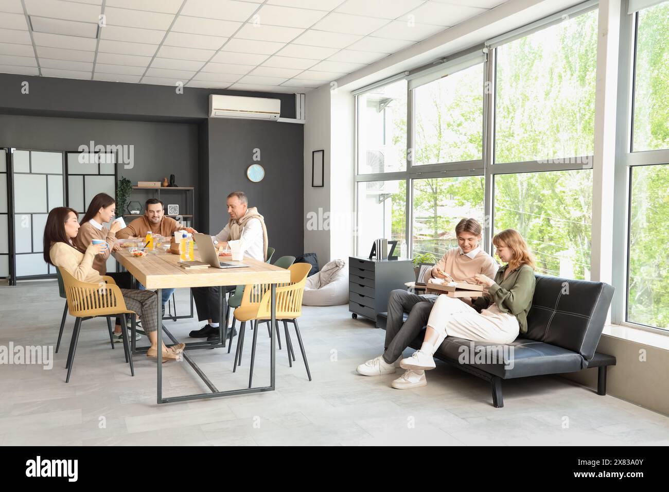 Business colleagues having lunch in office kitchen Stock Photo - Alamy