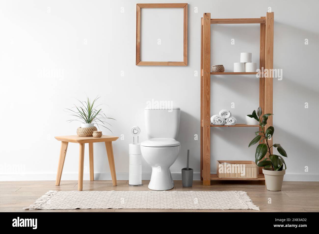 Interior of restroom with toilet bowl, coffee table and shelving unit ...